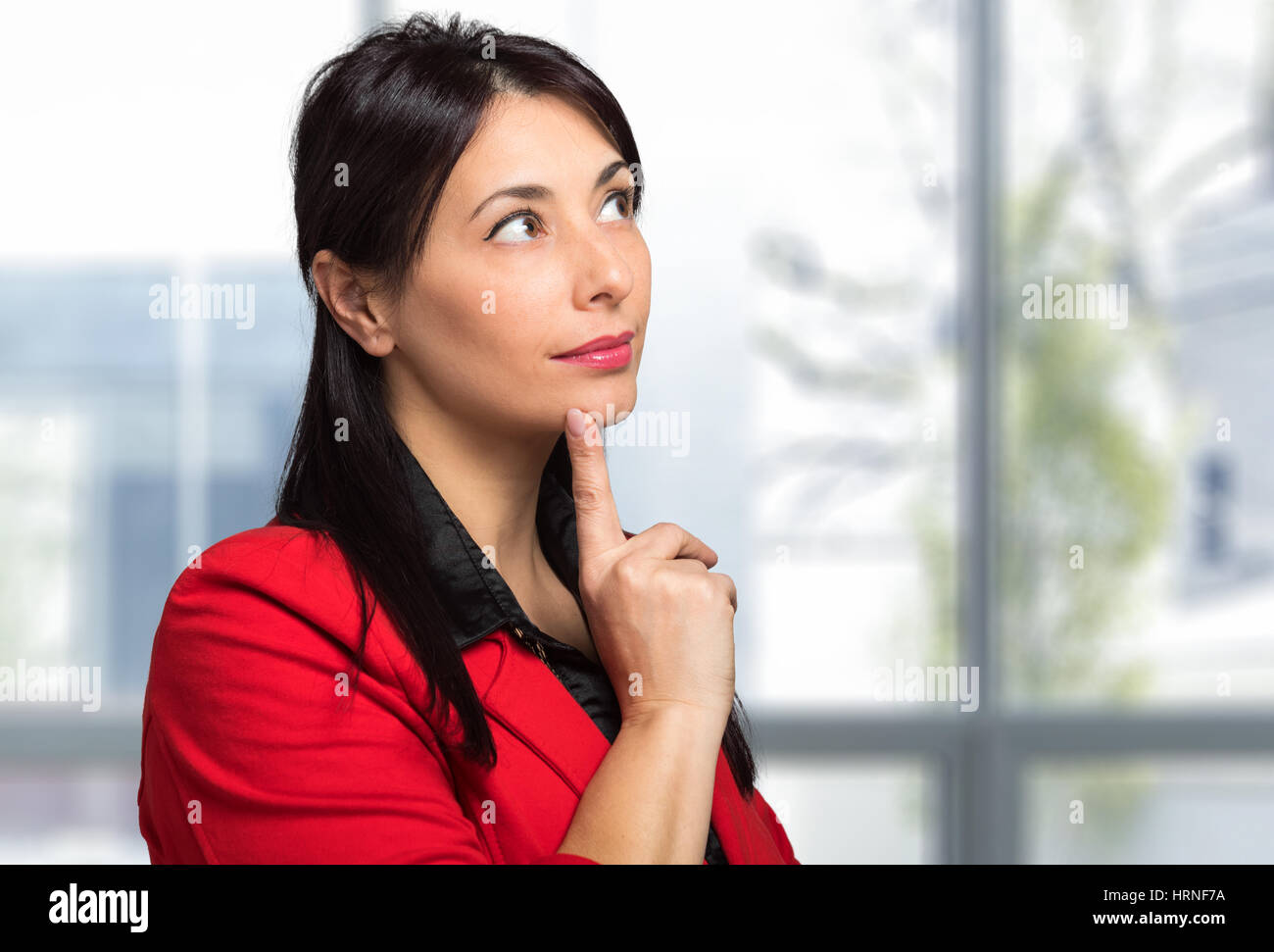 Young woman thinking at something Stock Photo - Alamy