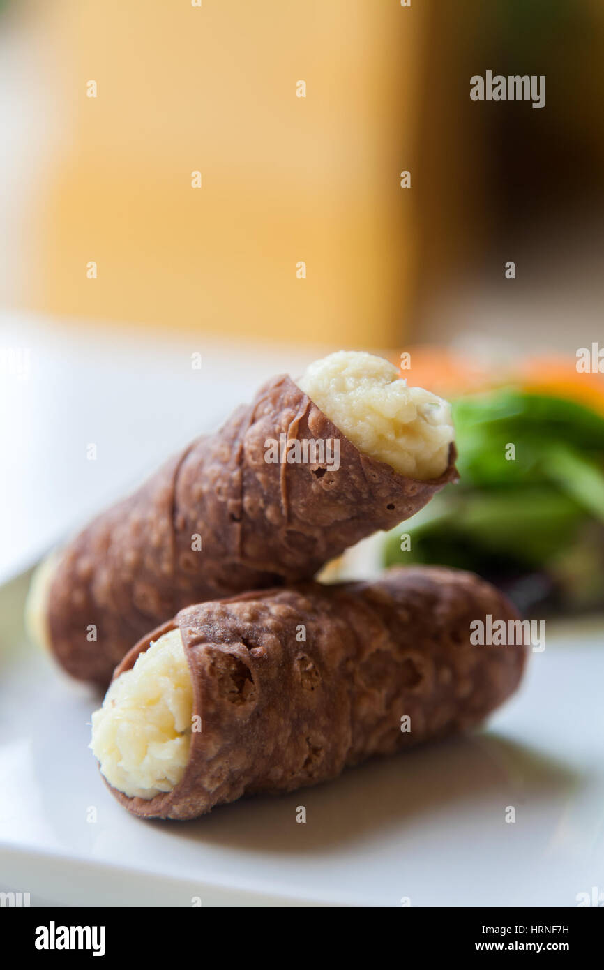 Two Tasty Cannoli on a Plate Stock Photo - Alamy