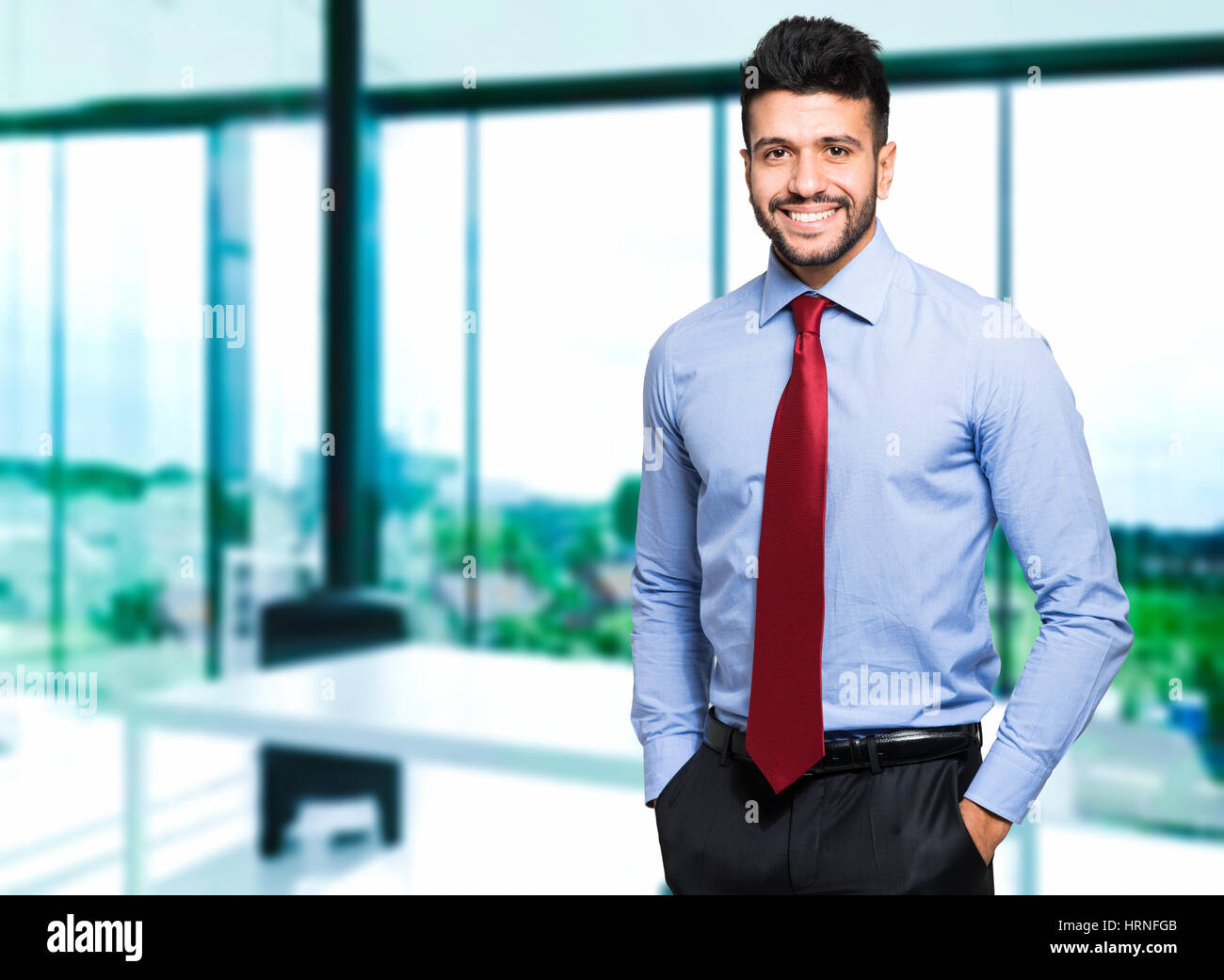 Portrait of a friendly businessman in his office Stock Photo - Alamy