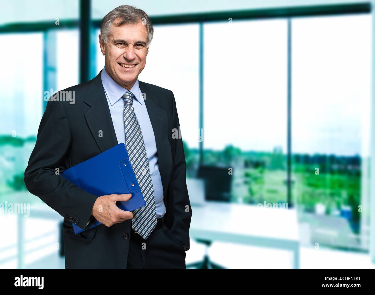 Handsome businessman at his desk in the office Stock Photo - Alamy