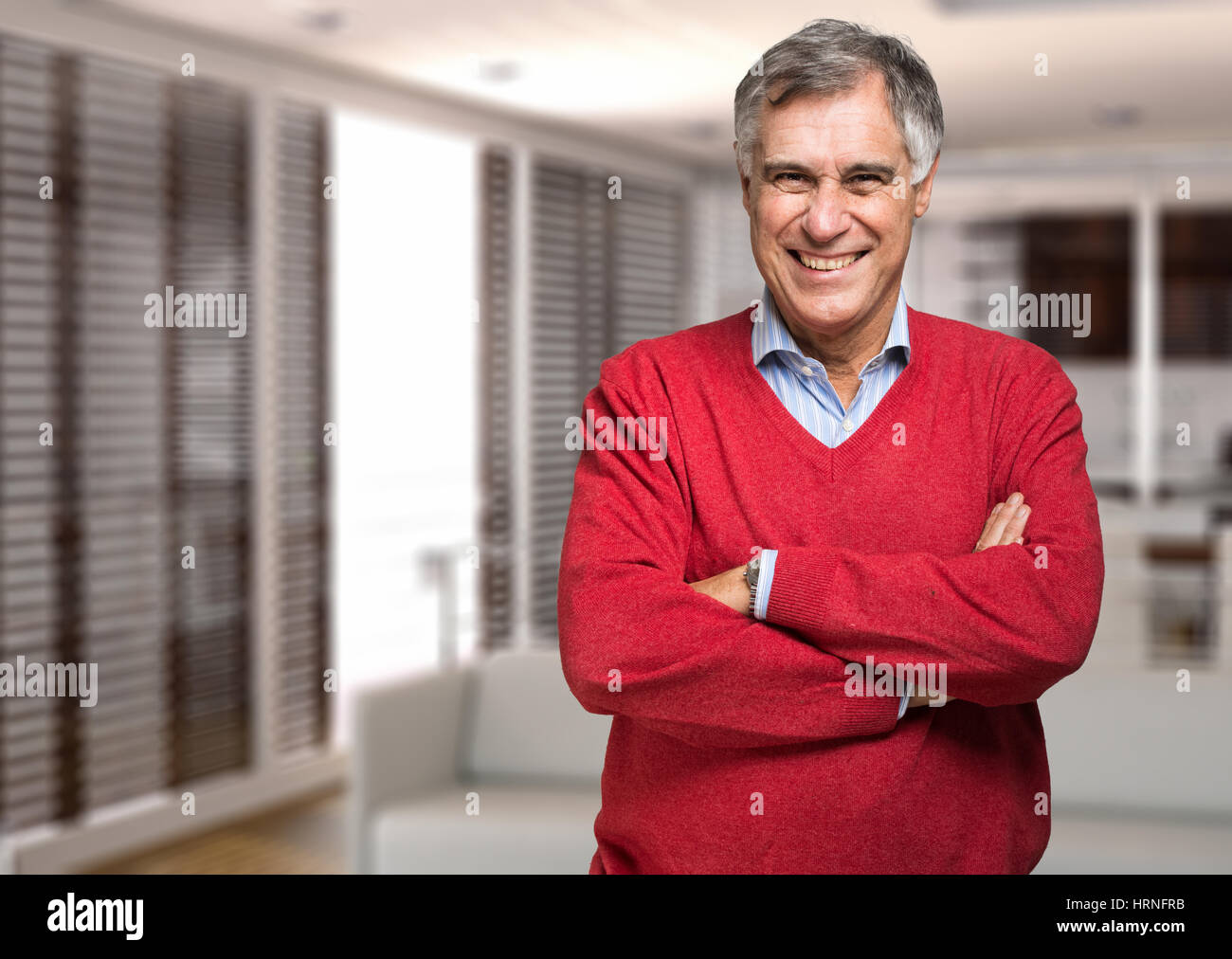 Handsome senior man standing against white background Stock Photo - Alamy