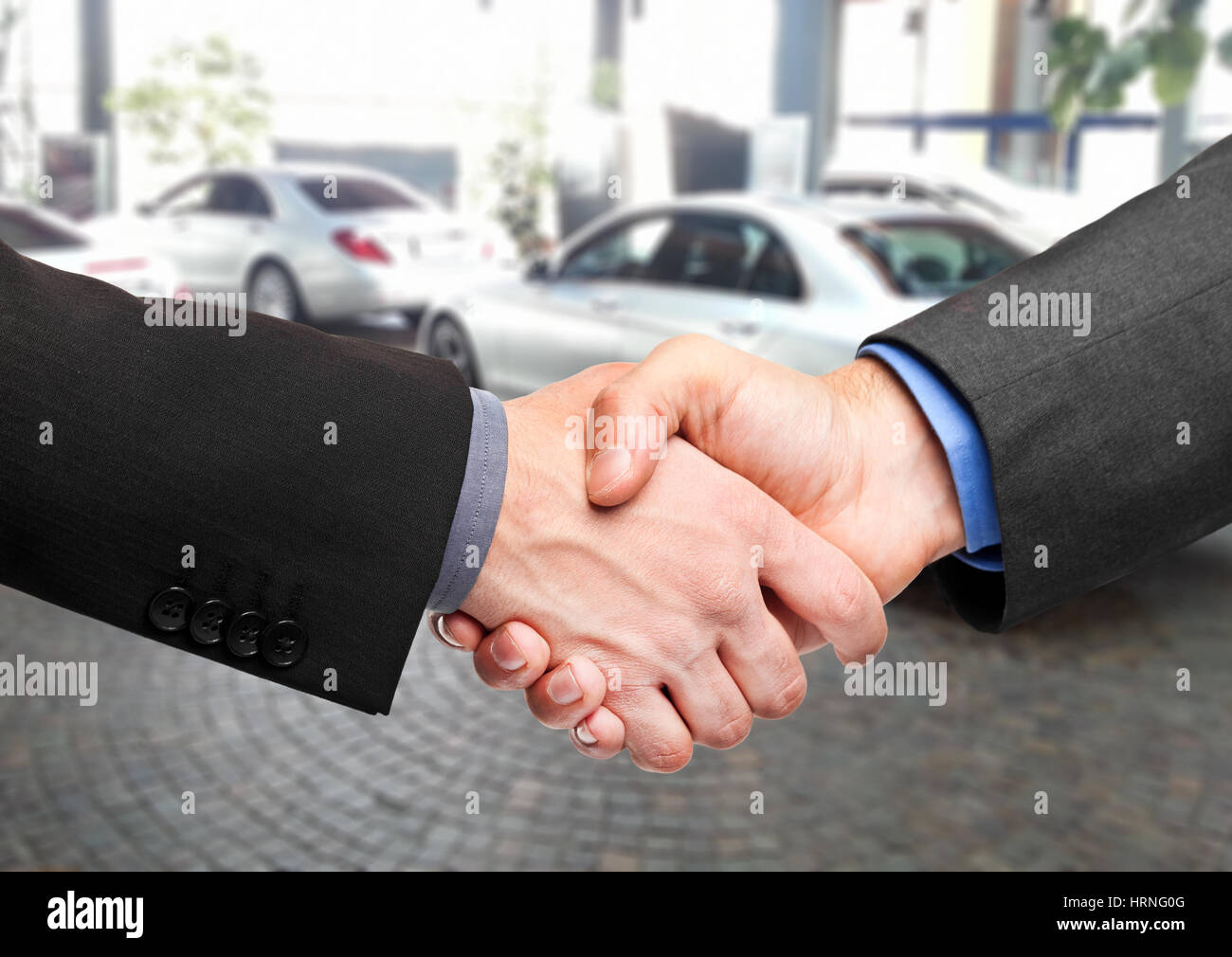 Business handshake to close the deal after buying a car Stock Photo - Alamy