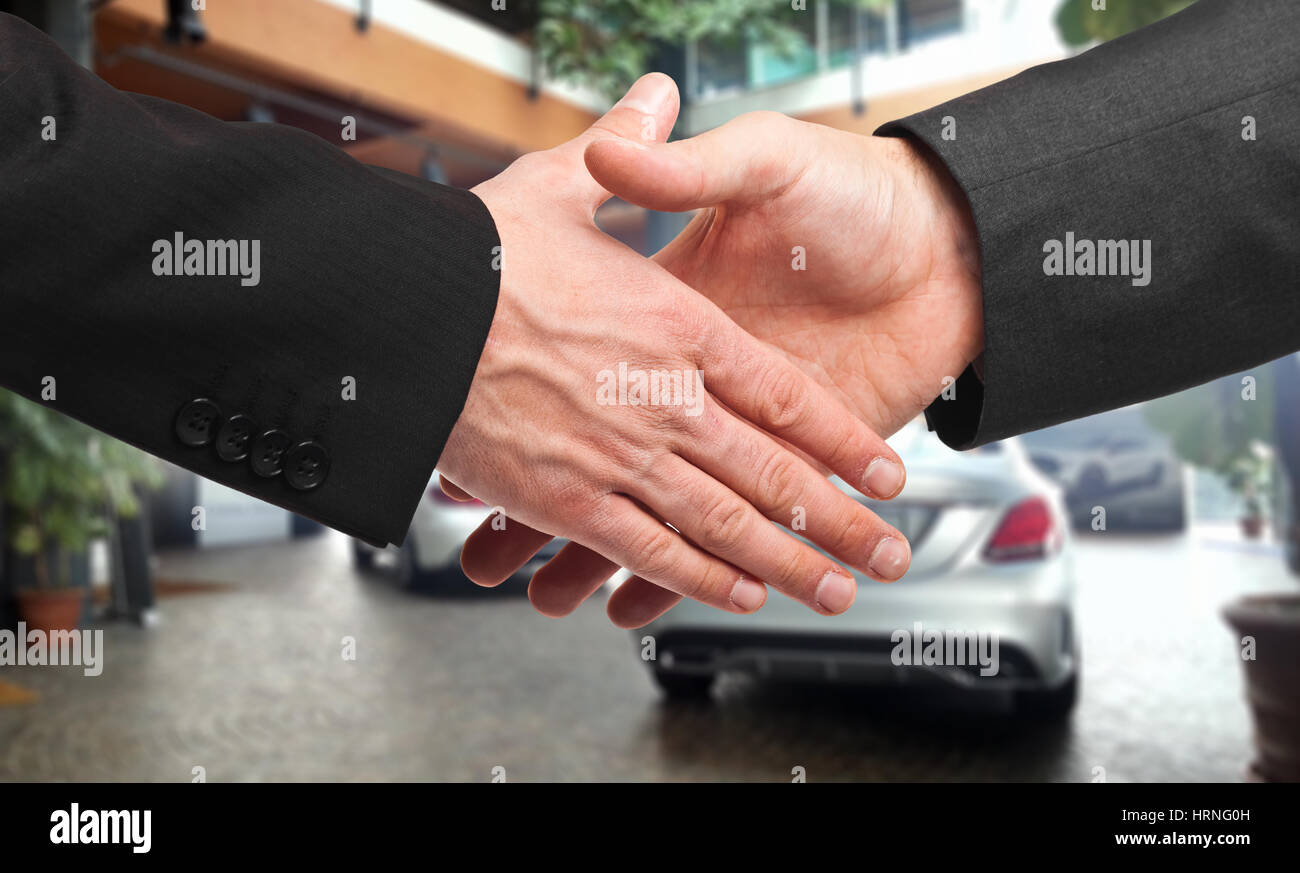 Business handshake to close the deal after buying a car Stock Photo - Alamy
