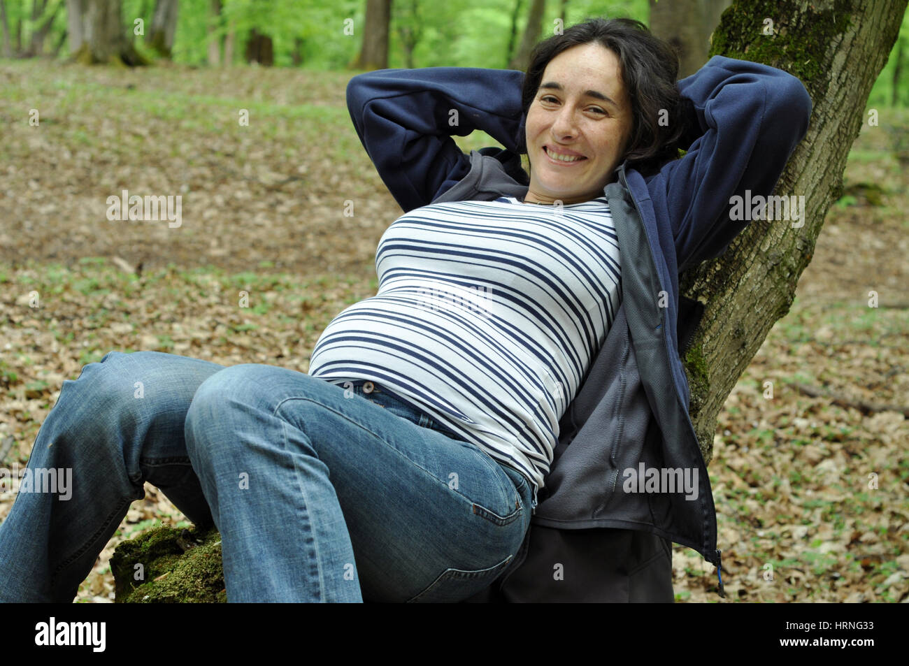 Calm pregnant woman relaxing in the forest Stock Photo - Alamy