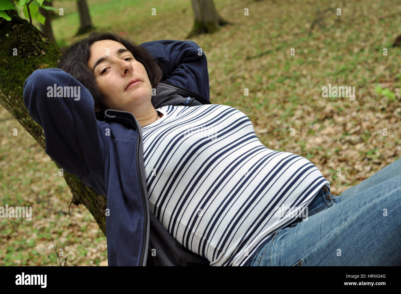 Calm pregnant woman relaxing in the forest Stock Photo - Alamy