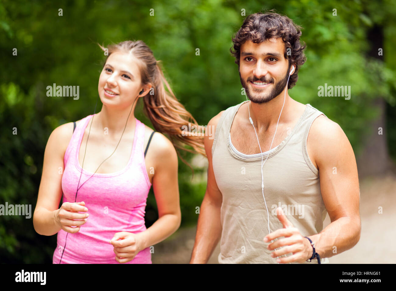 Couple running in a park Stock Photo - Alamy