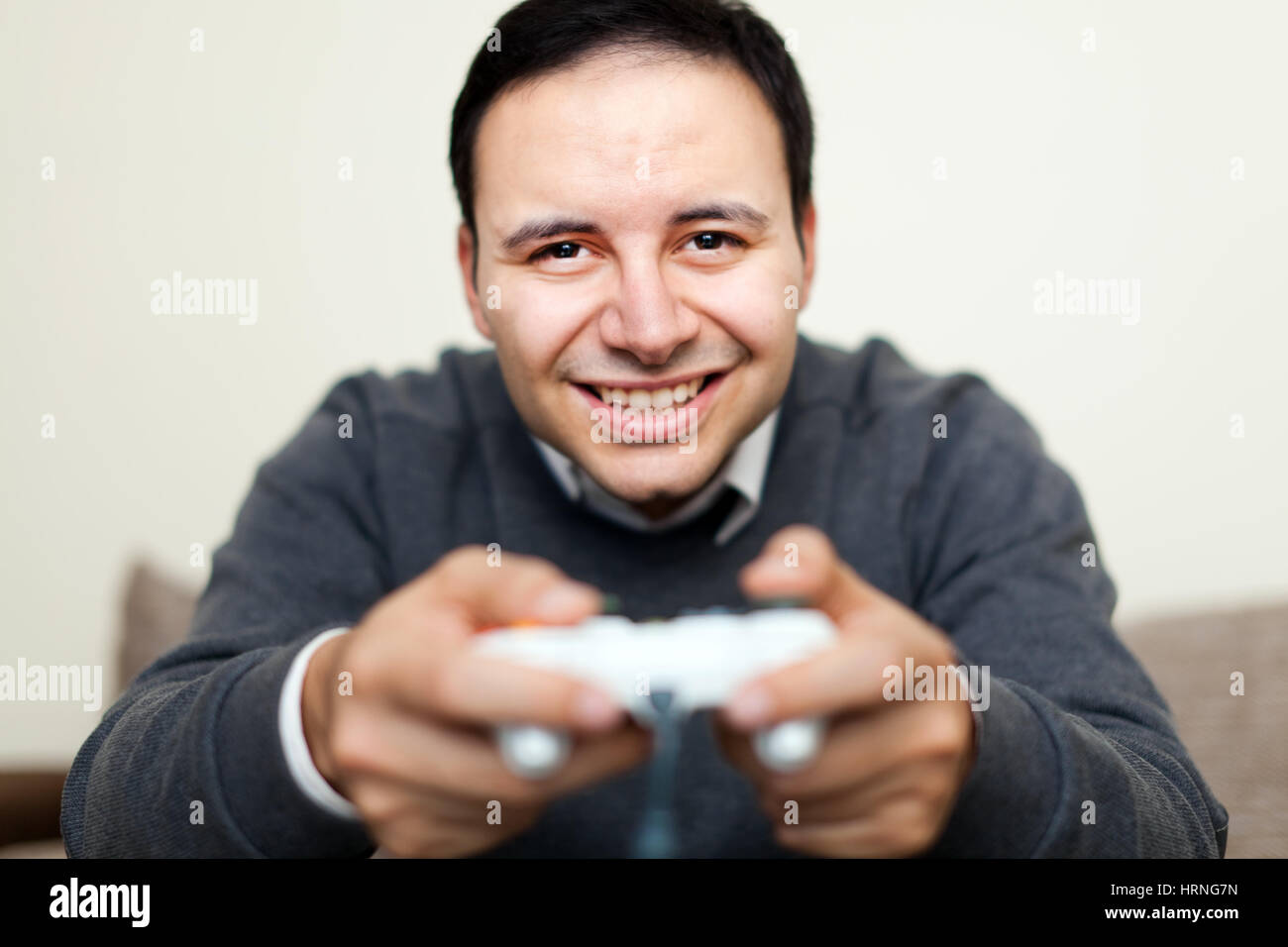 Man playing videogames on his sofa Stock Photo - Alamy