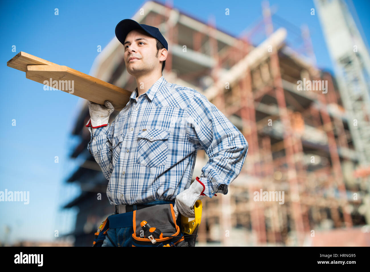 Carpenter at work in a construction site Stock Photo - Alamy
