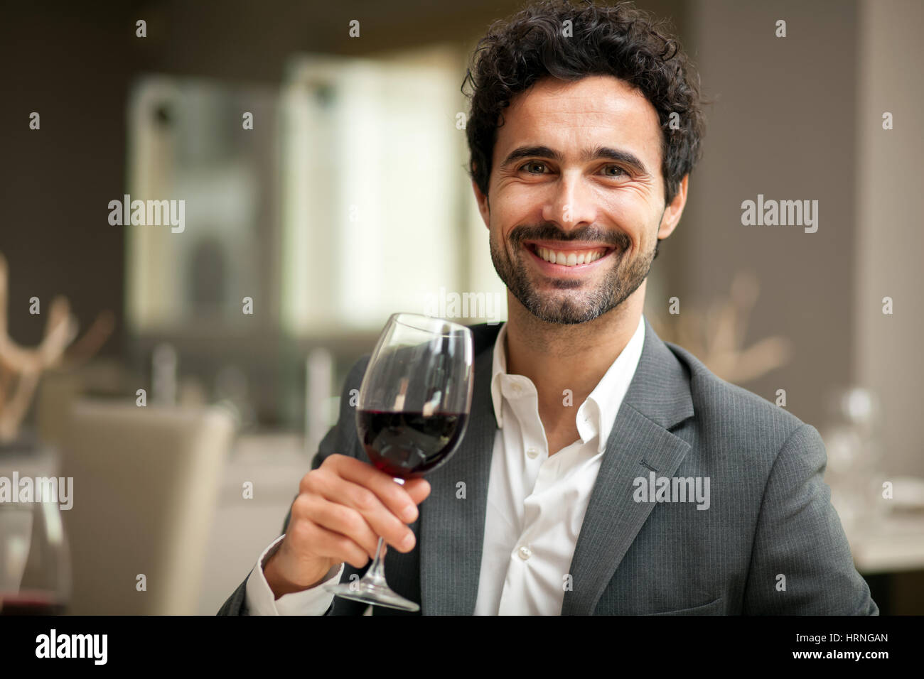 Man tasting a glass of red wine in a restaurant Stock Photo - Alamy