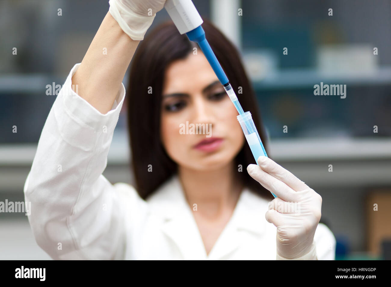 Female researcher analyzing a test tube Stock Photo - Alamy