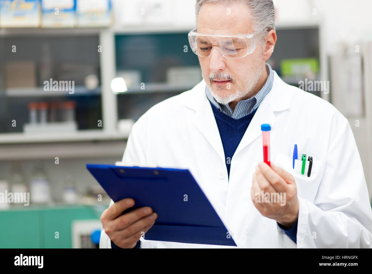 Scientists examining a test tube in a laboratory Stock Photo - Alamy