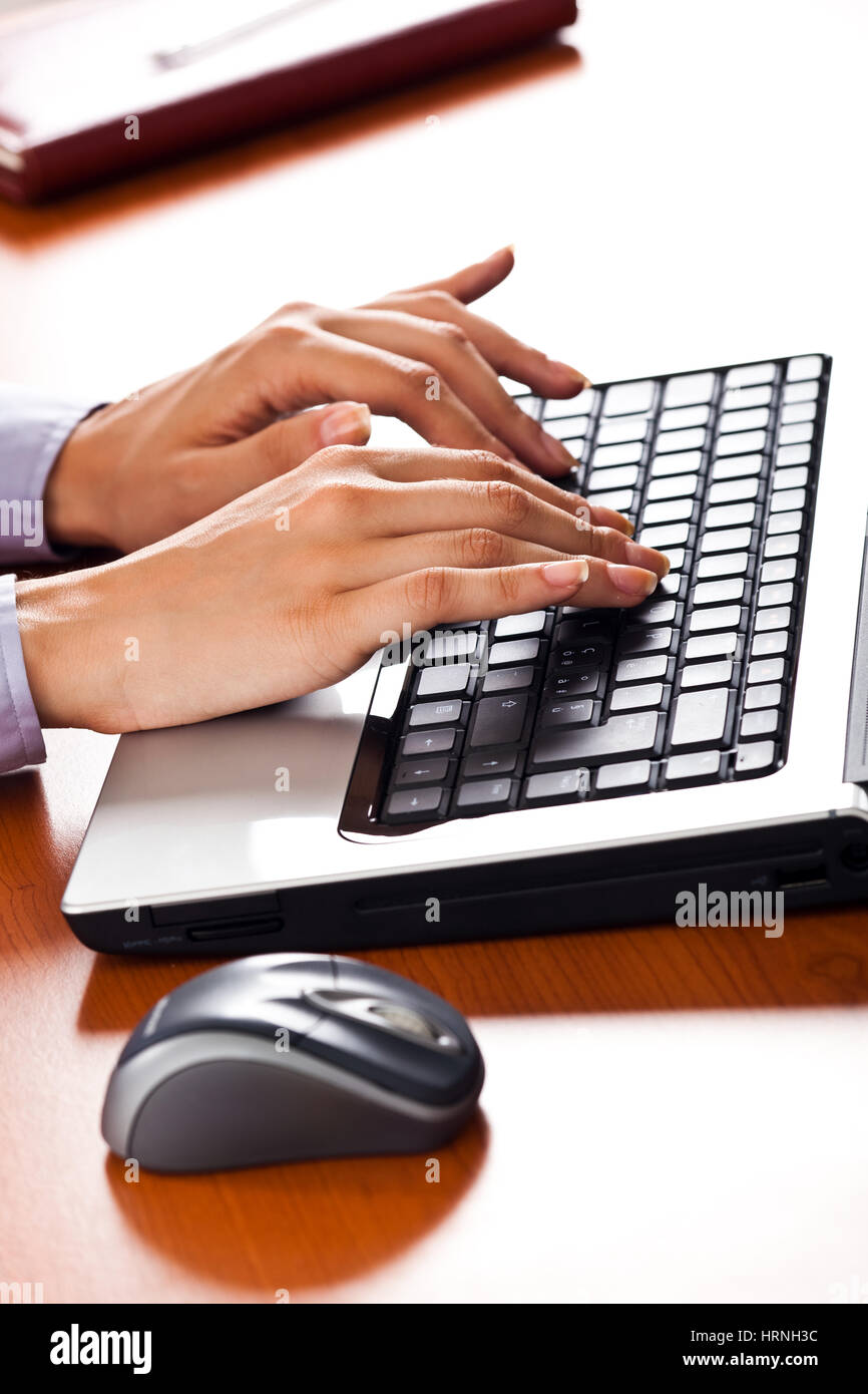 Female hands typing on a laptop Stock Photo - Alamy