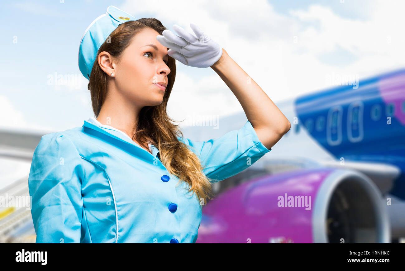 Beautiful hostess with airplane on the background Stock Photo - Alamy