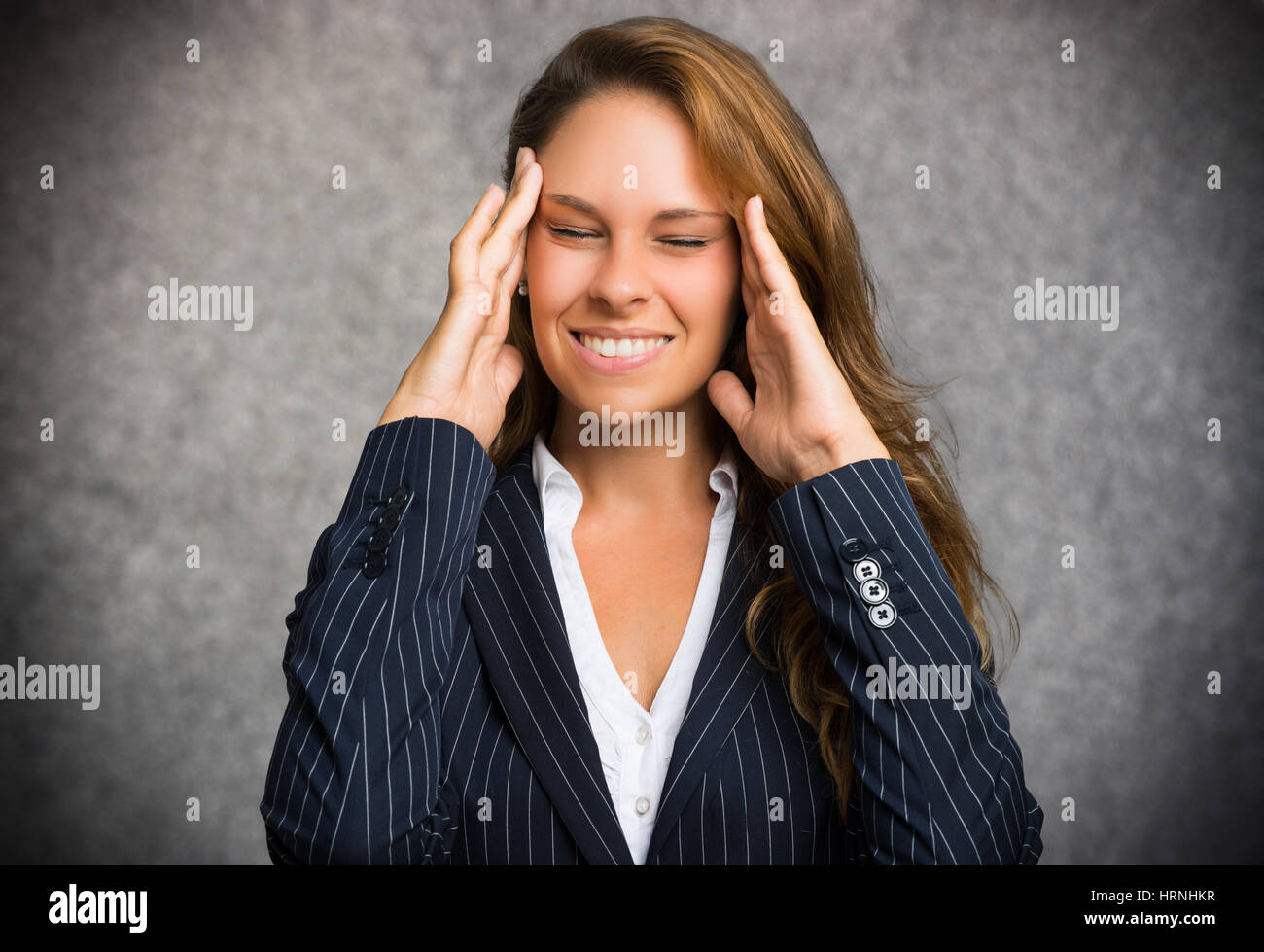 Stressed woman having a strong headache Stock Photo - Alamy