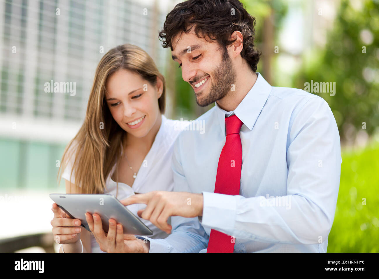 Business people using a digital tablet Stock Photo - Alamy
