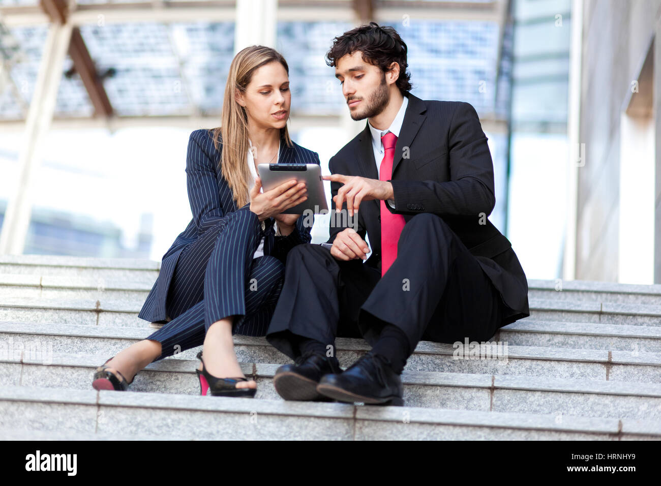 Business people using a digital tablet Stock Photo - Alamy