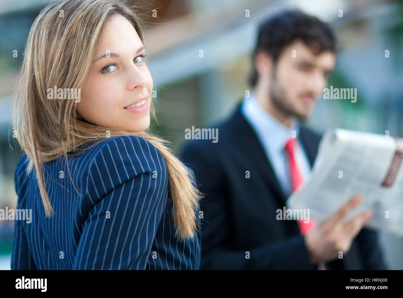 Young businessman businesswoman reading newspaper hi-res stock ...