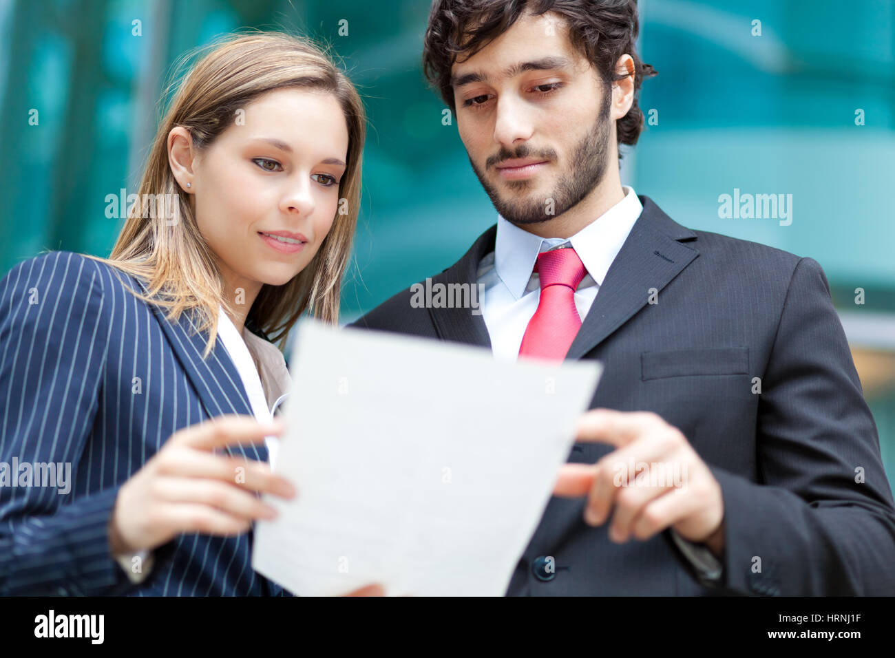 Business people reading a document Stock Photo - Alamy