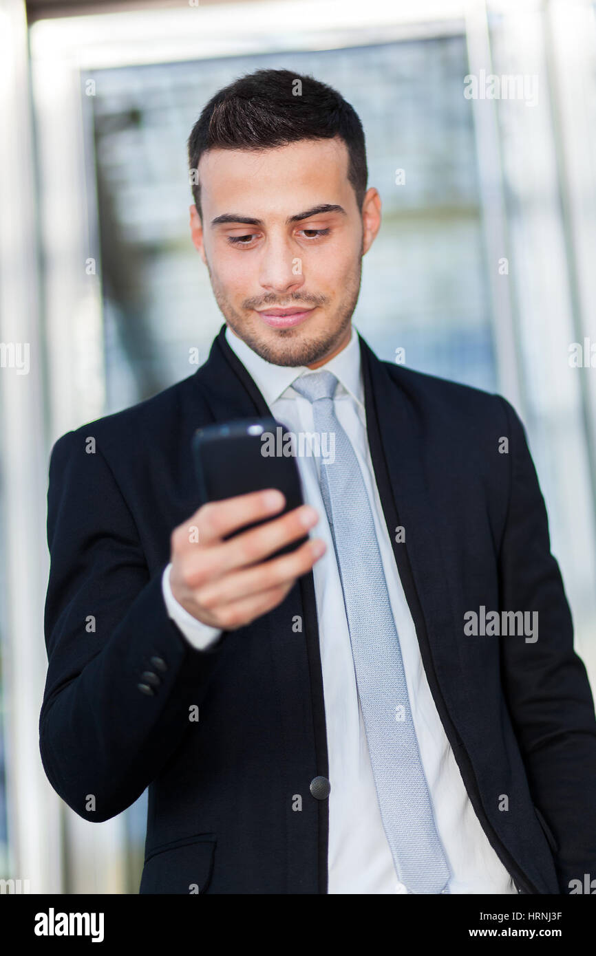 Man using his mobile phone Stock Photo - Alamy