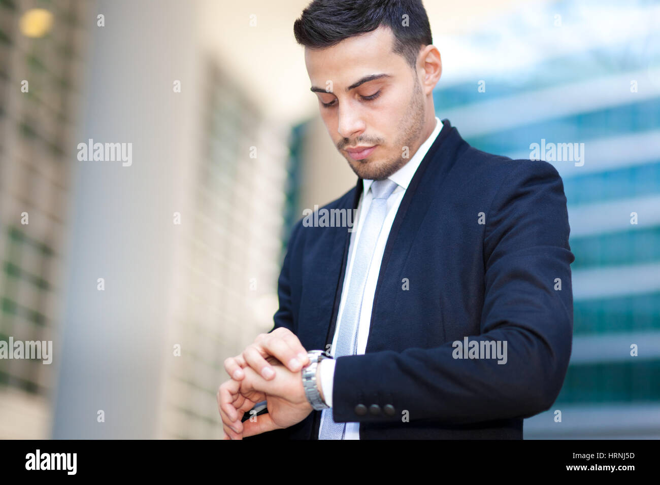 Business man watching the time Stock Photo - Alamy