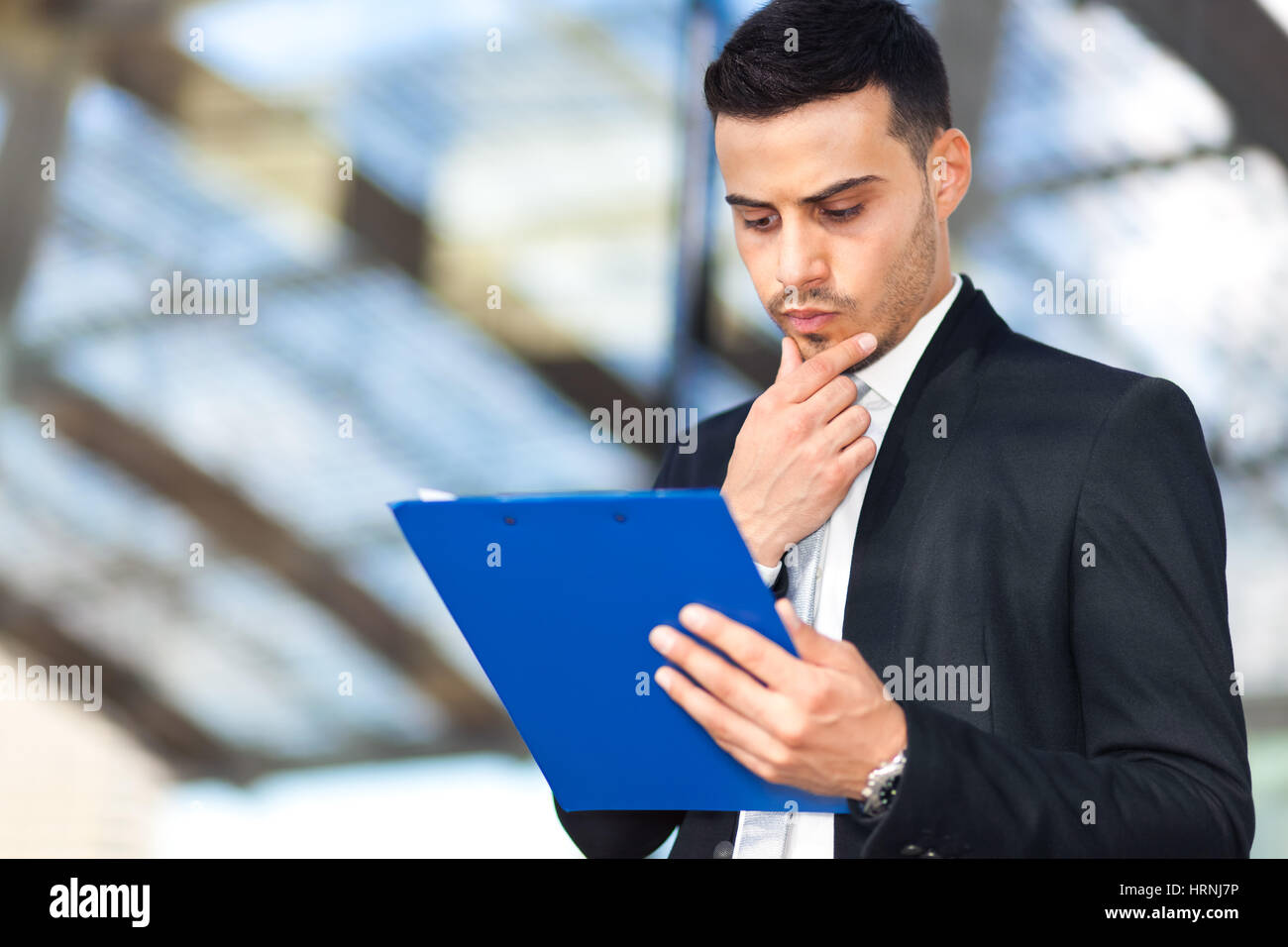 Handsome businessman reading documents hi-res stock photography and ...