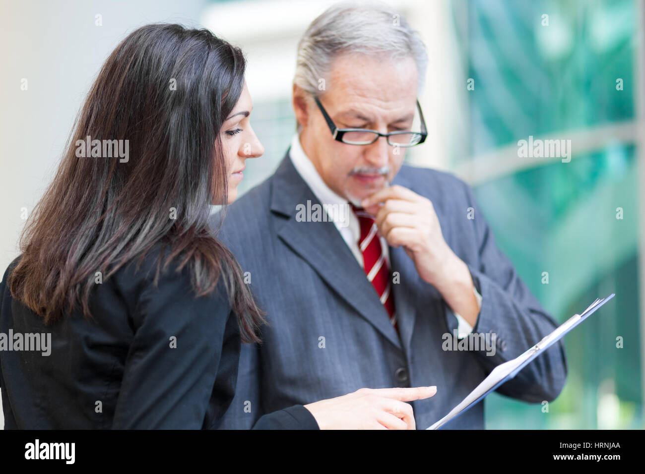 Business people reading a document Stock Photo - Alamy