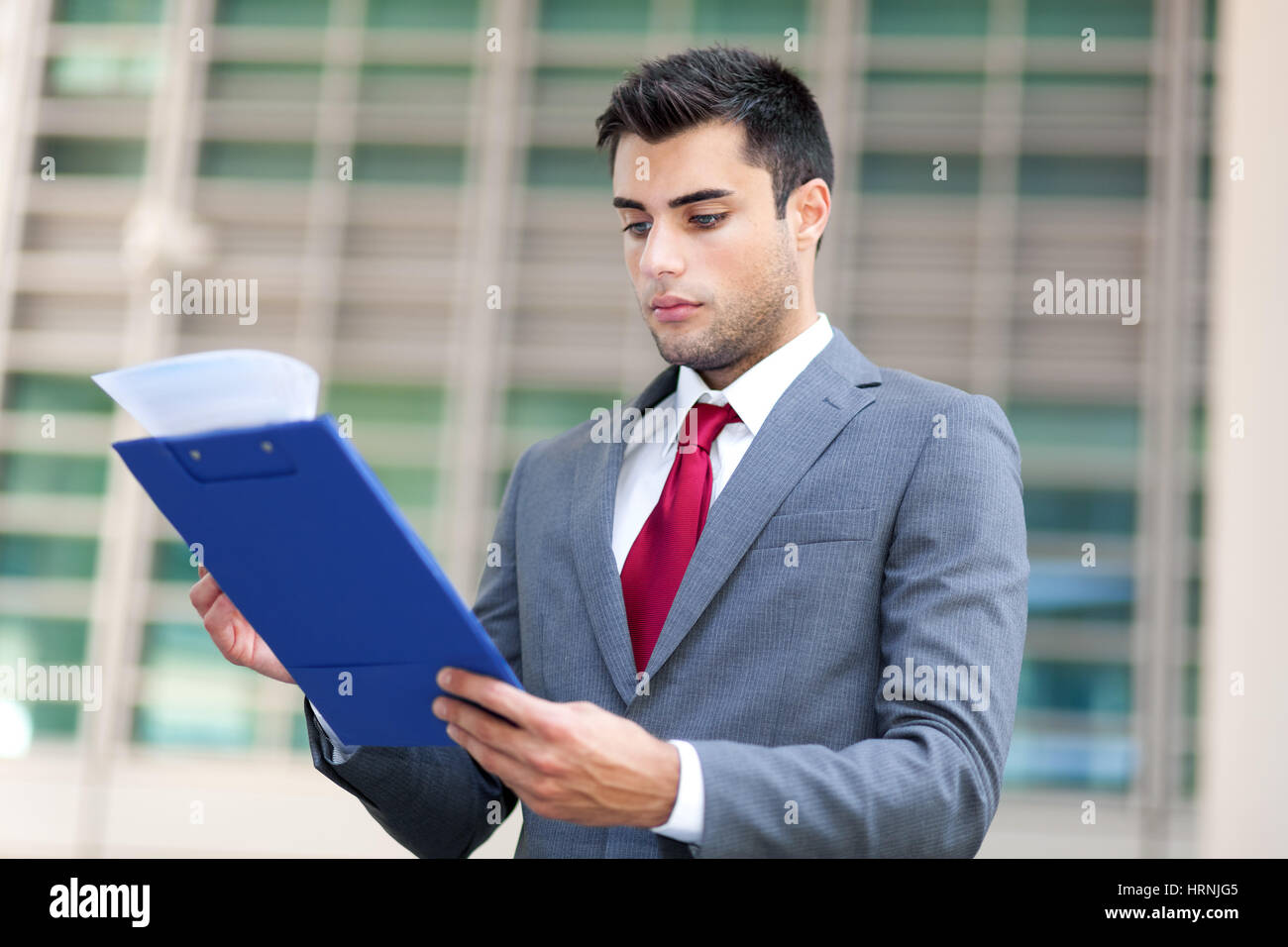 Young manager reading some documents outdoor Stock Photo - Alamy