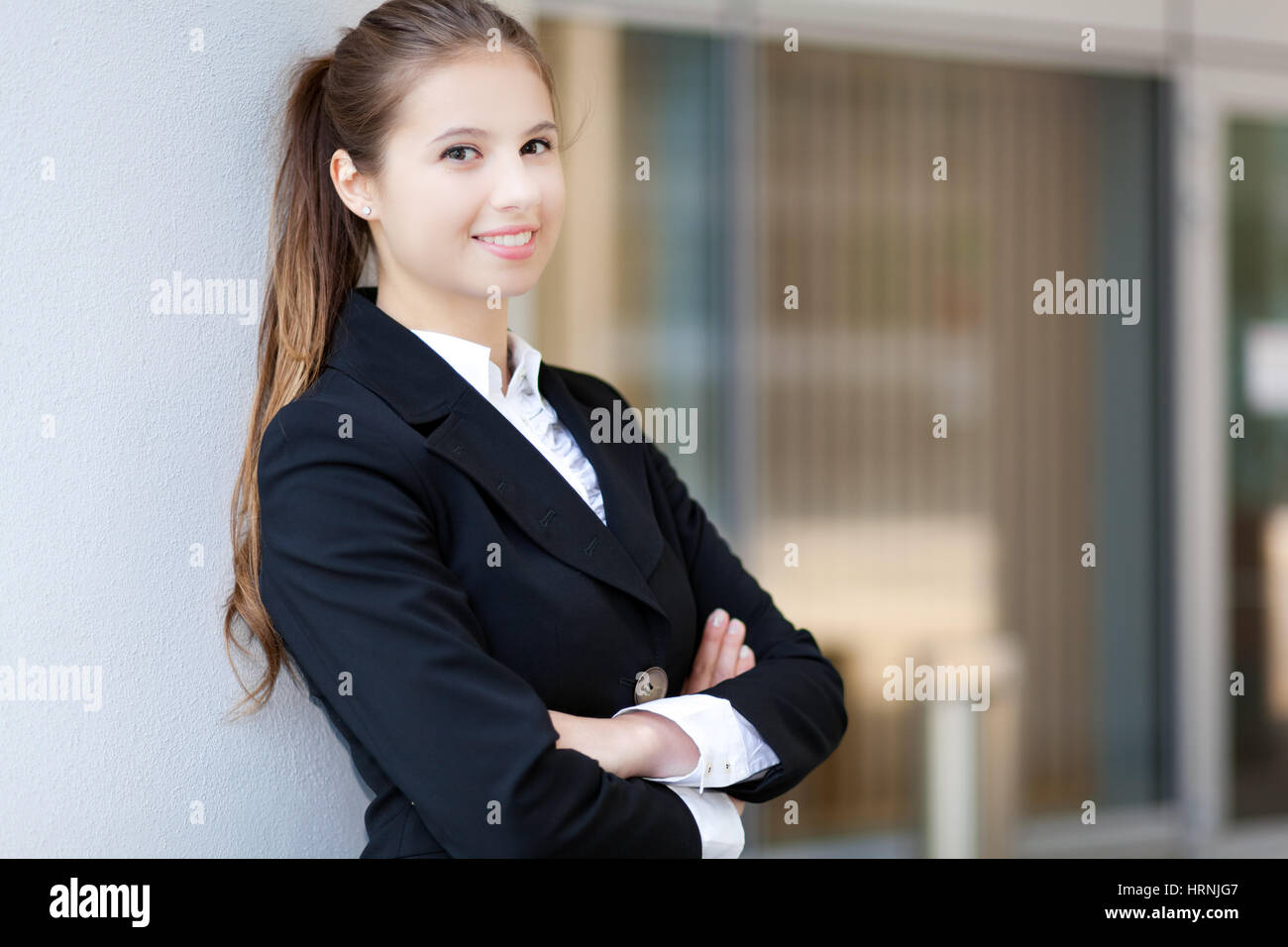 Smiling female manager in urban setting Stock Photo - Alamy