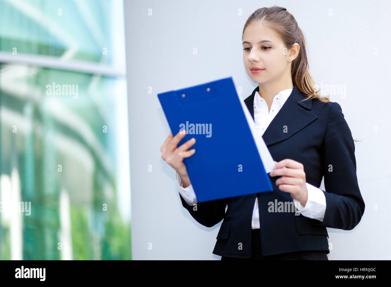Business woman portrait reading some documents Stock Photo - Alamy
