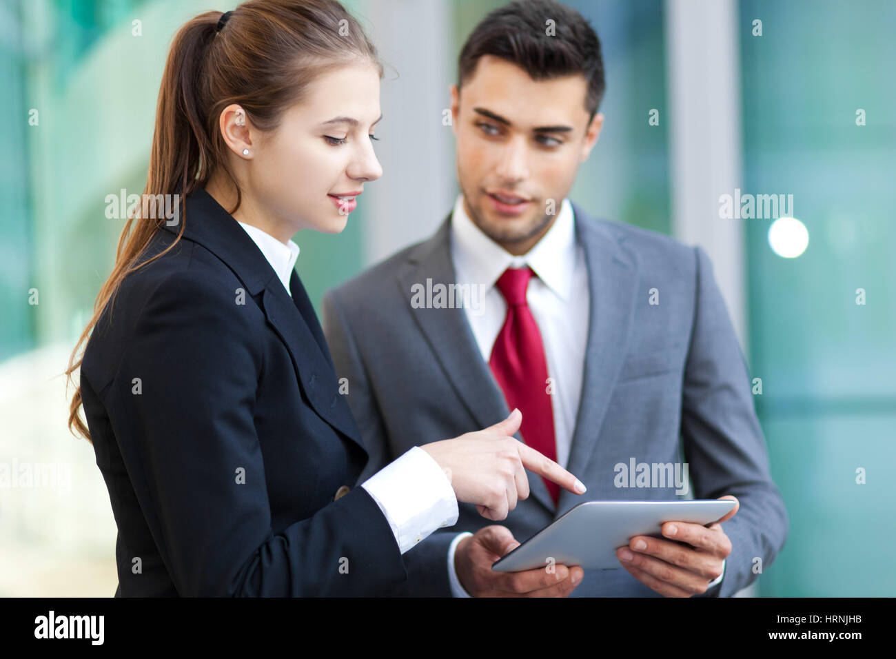 Business people using a digital tablet Stock Photo - Alamy