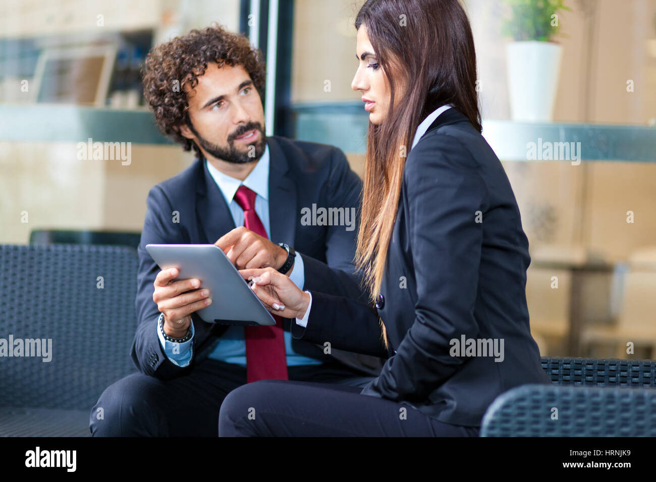 Business people using a digital tablet Stock Photo - Alamy