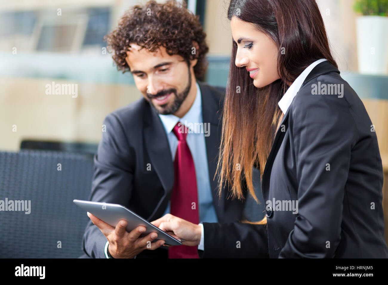 Business people using a digital tablet Stock Photo - Alamy