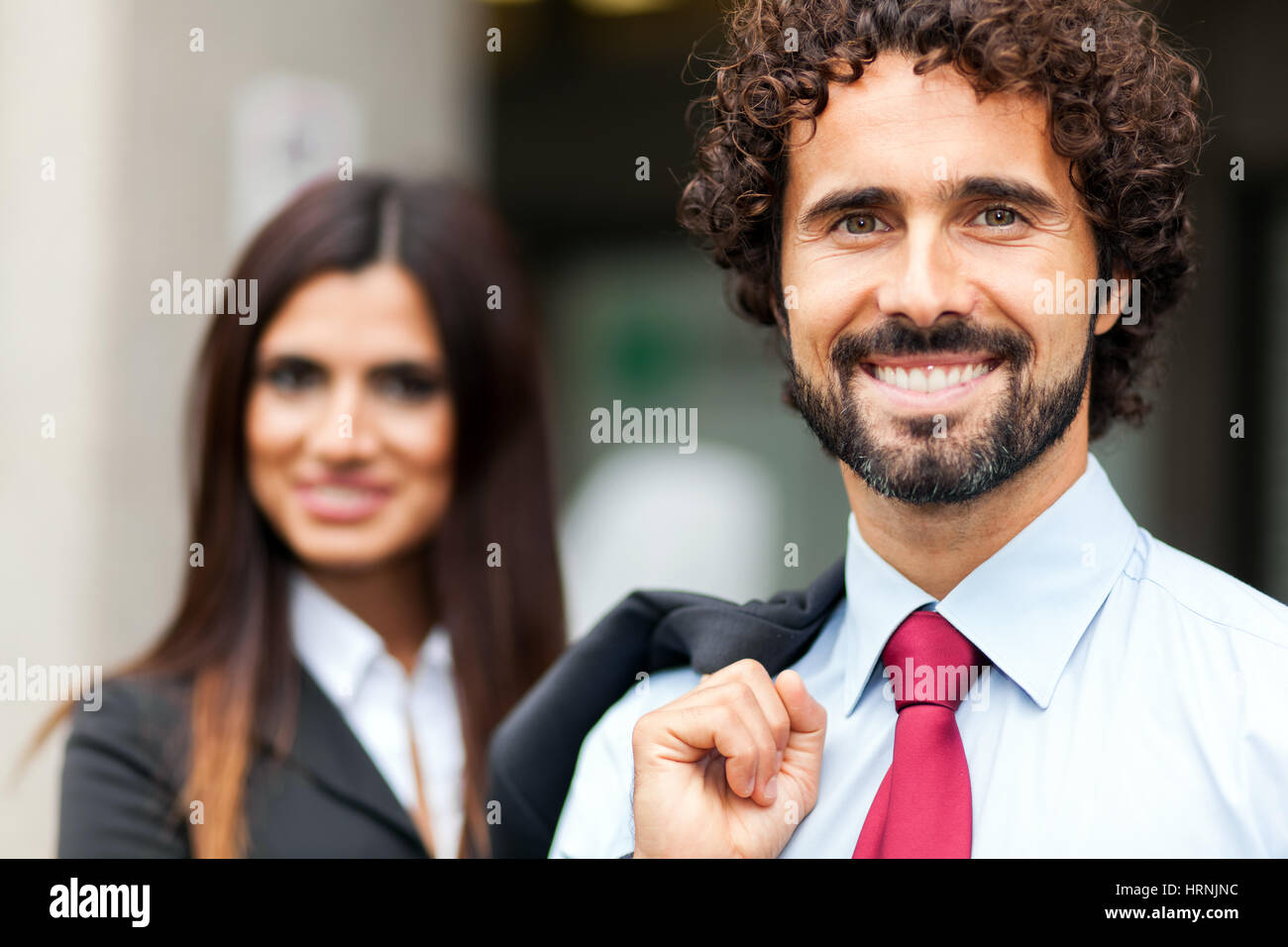 Two smiling business people outdoor Stock Photo - Alamy