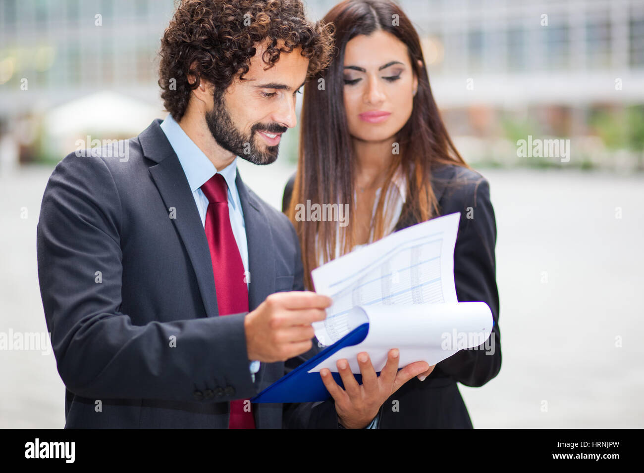 Two business people reading some documents Stock Photo - Alamy