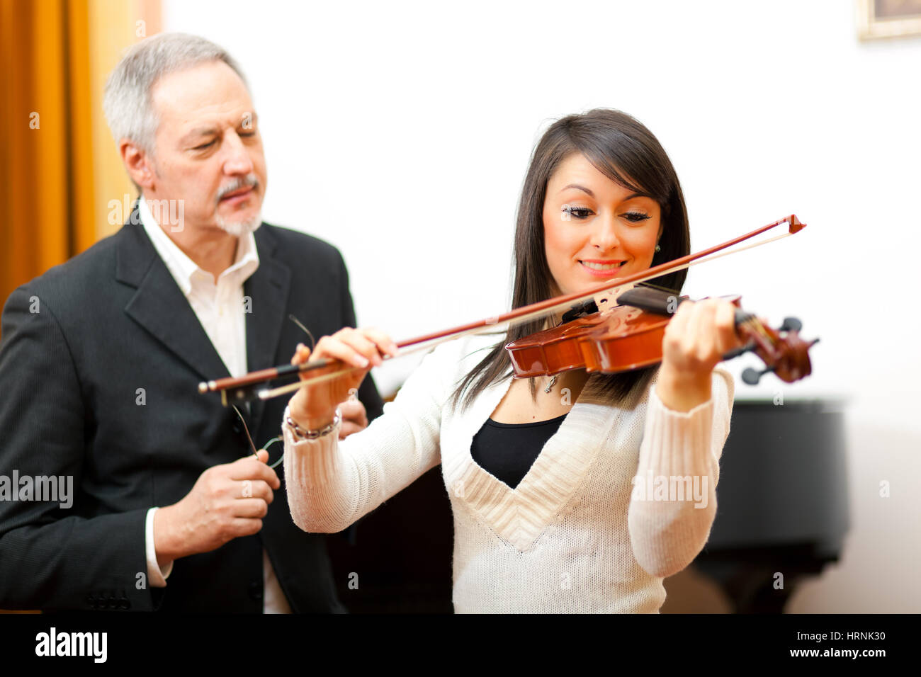 Teacher teaching to play violin Stock Photo - Alamy