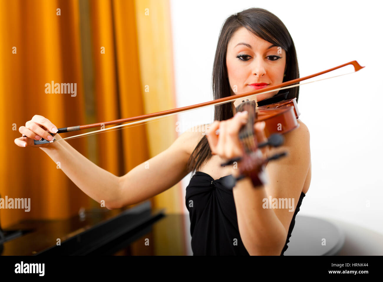 Beautiful woman playing violin Stock Photo - Alamy