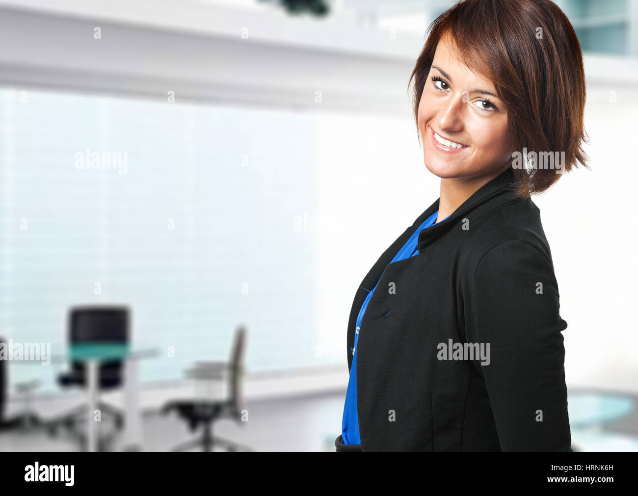 Smiling female manager in the office Stock Photo - Alamy