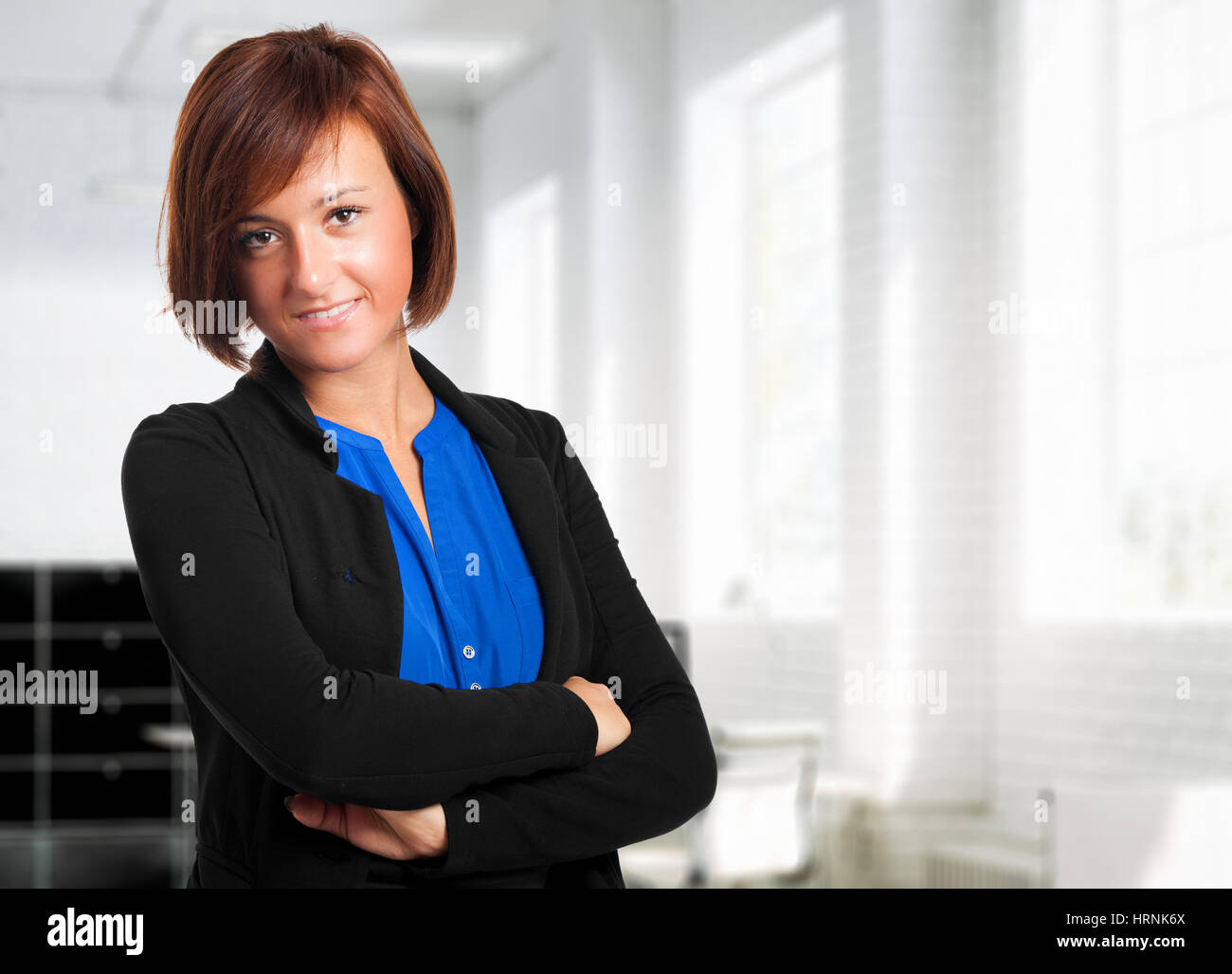 Smiling female manager in the office Stock Photo - Alamy