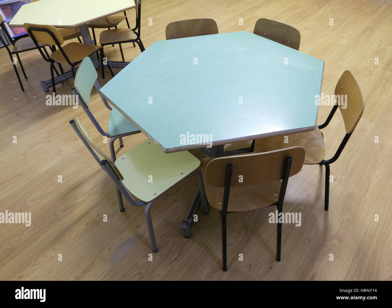 Hexagonal table with the chairs of a school class for children without ...