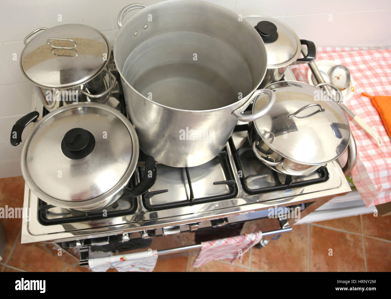 many large pots with steel lid on the stove of the large industrial ...