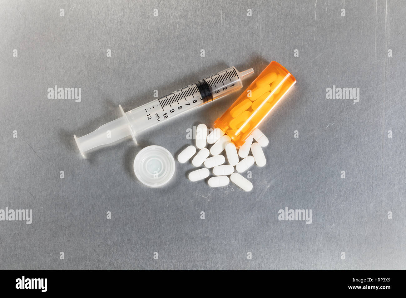 Flat view of painkiller pills with open bottle and syringe. Opioid ...