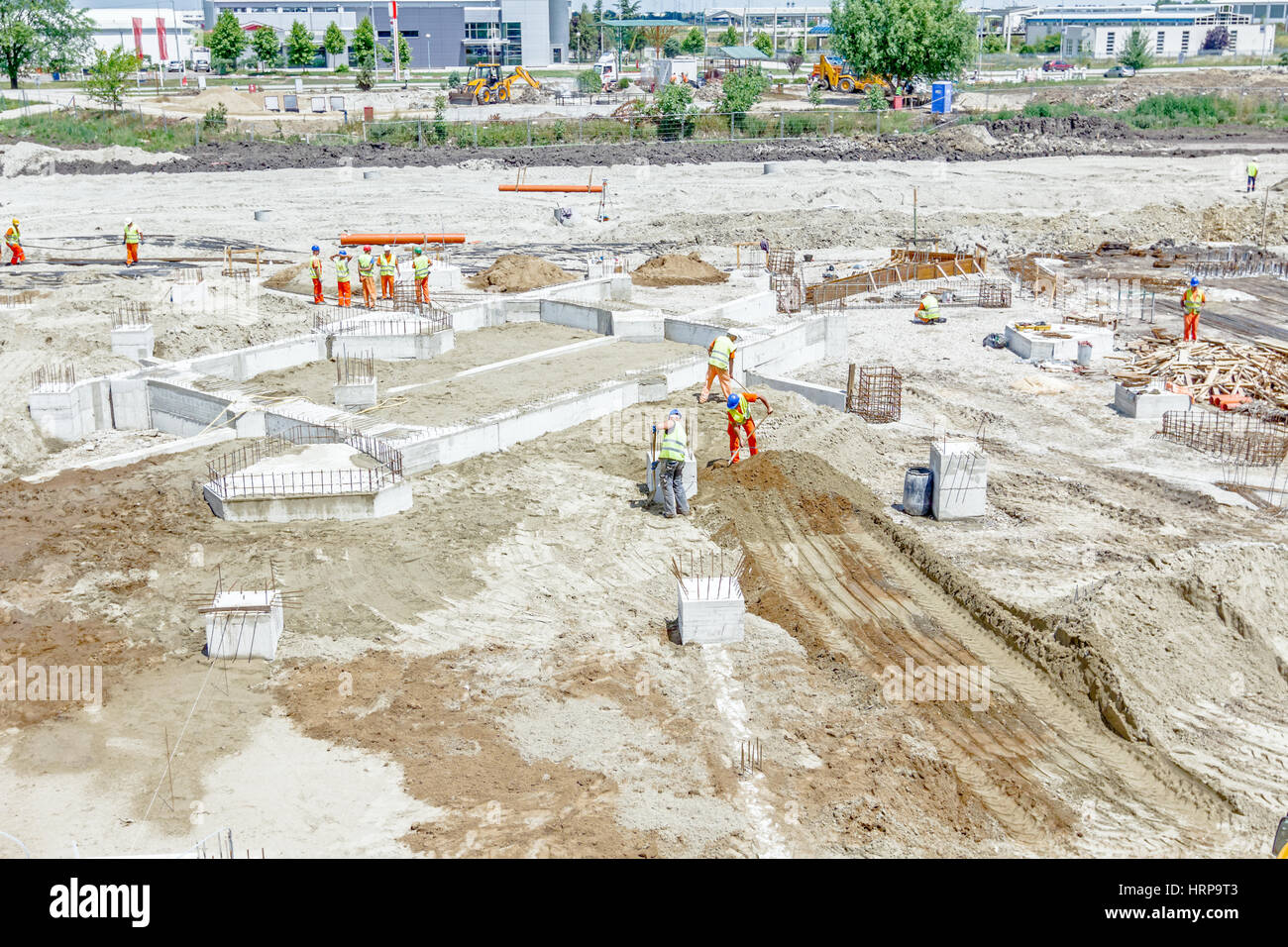 Above view on concrete base with reinforcement at building site, team ...