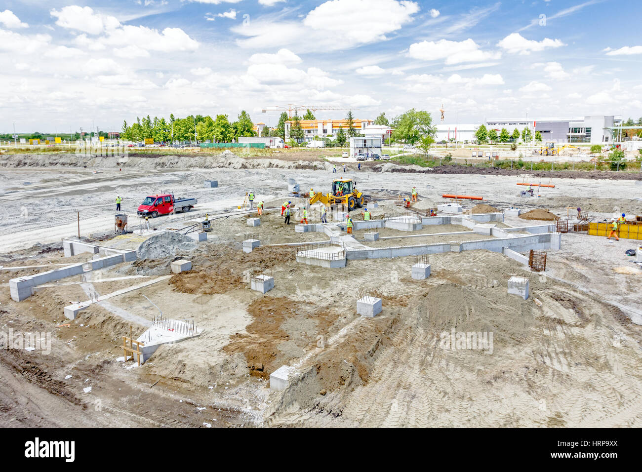 Above view on concrete base with reinforcement at building site, team ...