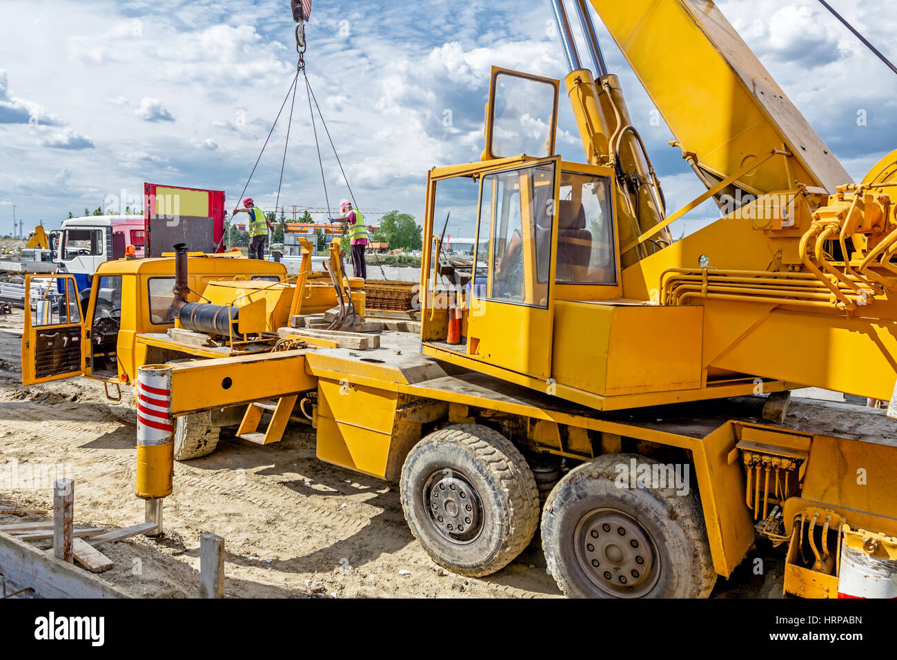 Side view on open cabin of the yellow mobile crane with erected long ...