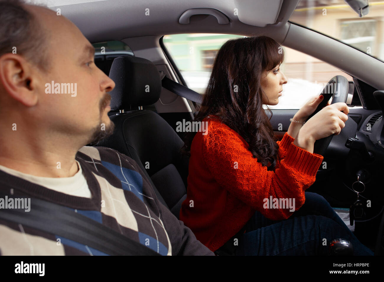 Driving instructor observing how female student driving Stock Photo - Alamy