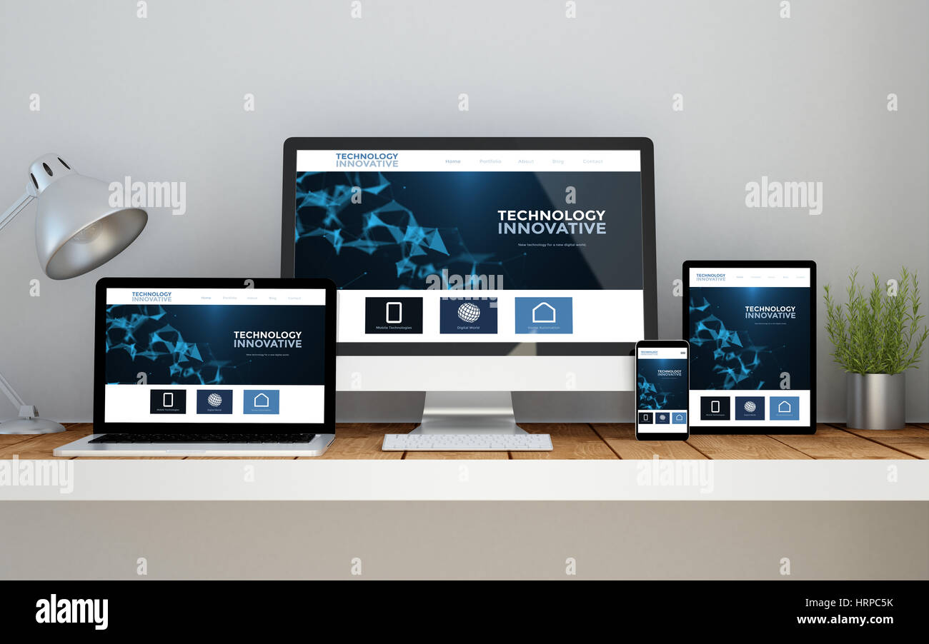 A computer, laptop, smartphone and tablet on a desktop workspace with ...