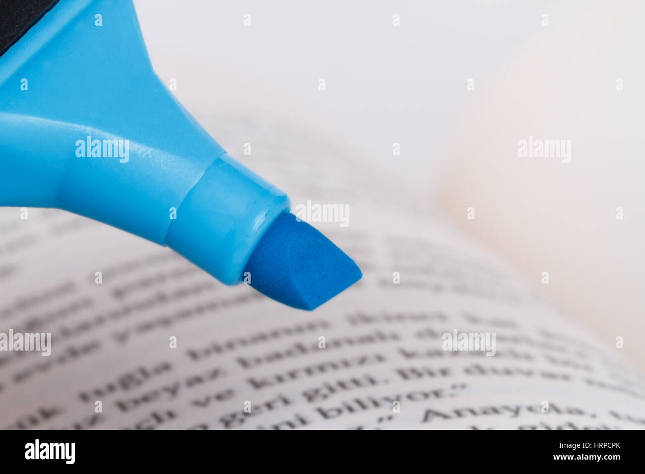 Close up detailed side view of blue highlighter pen on paper Stock ...