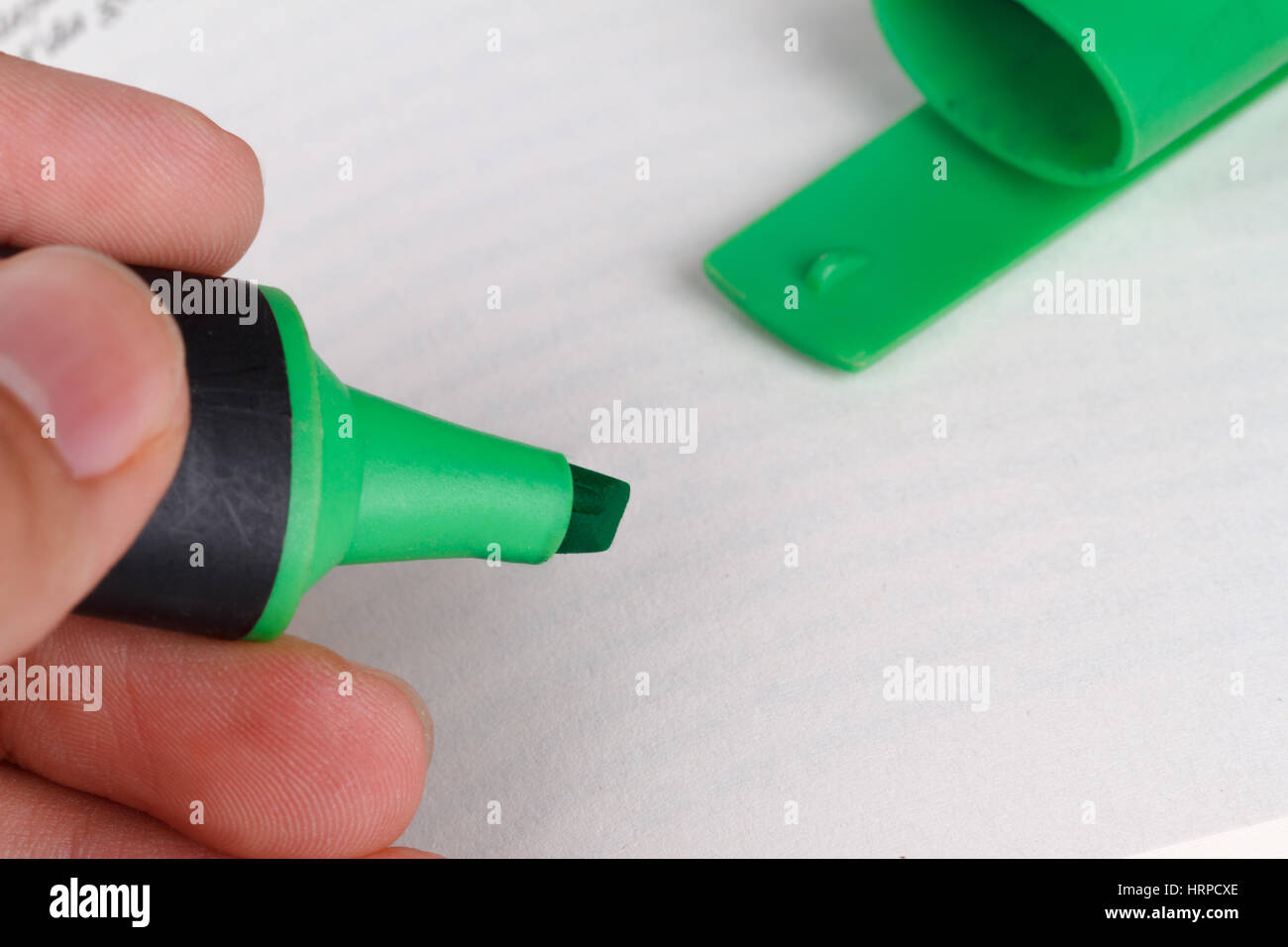 Close up detailed side view of green highlighter pen on paper Stock ...