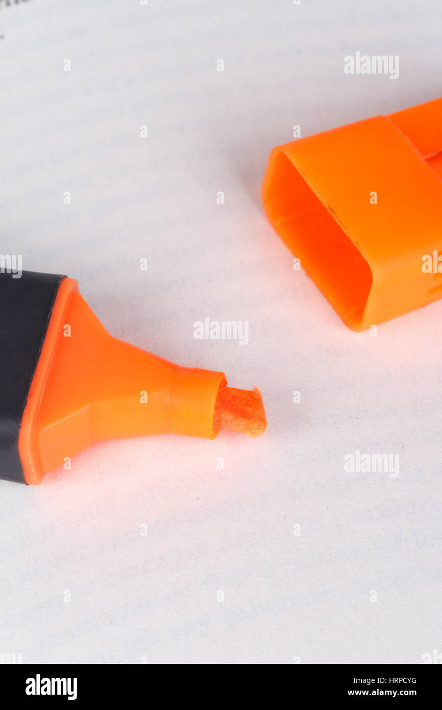 Close up detailed side view of orange highlighter pen on paper Stock ...