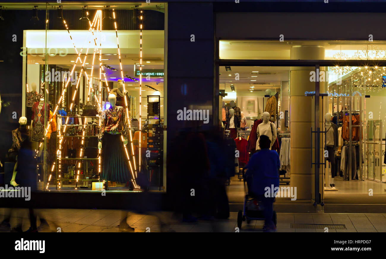 People out shopping on the High Street at nighttime Stock Photo - Alamy